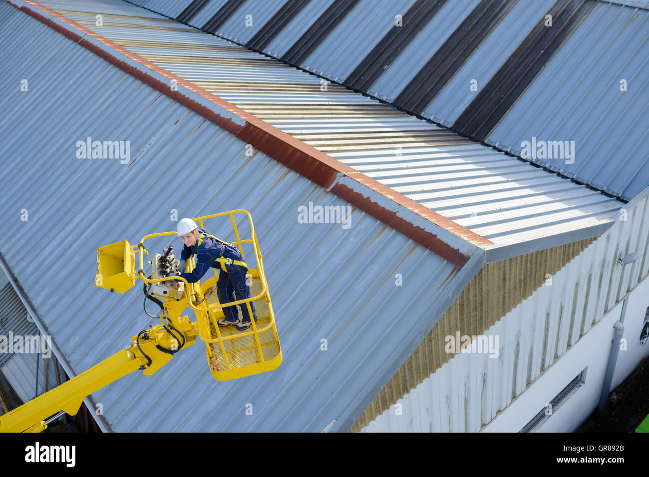 Woman in cherry picker cage hi-res stock photography and images - Alamy