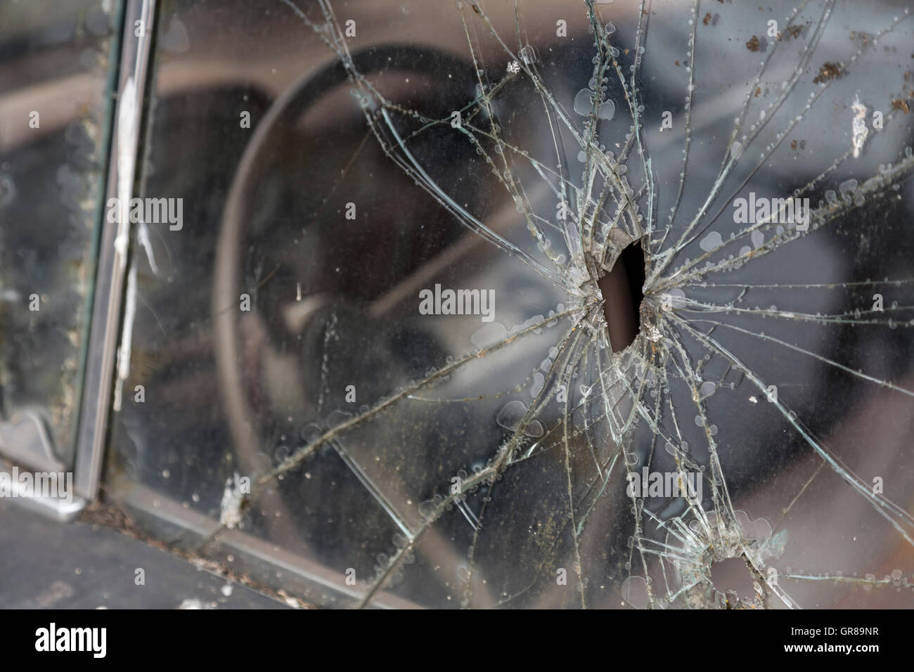 Car Window After A Robbery Has A Bullet Hole Stock Photo - Alamy