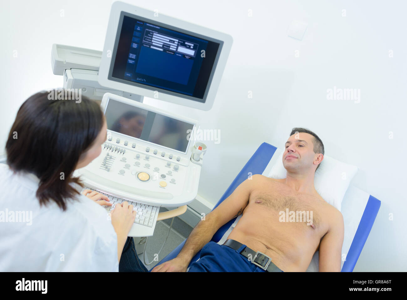 Nurse with patient and ultrasound machine Stock Photo - Alamy