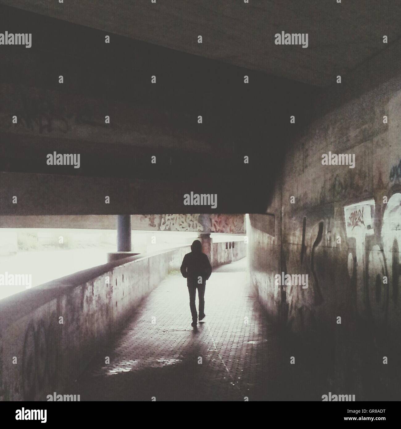 Silhouette man walking under bridge hi-res stock photography and images ...