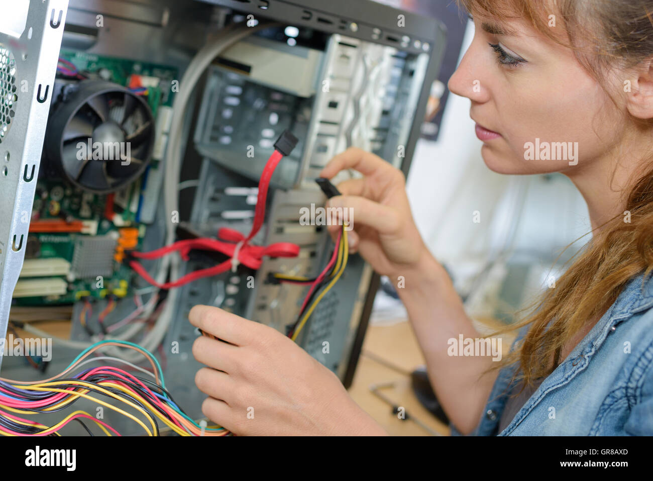 Young lady rewiring computer Stock Photo - Alamy