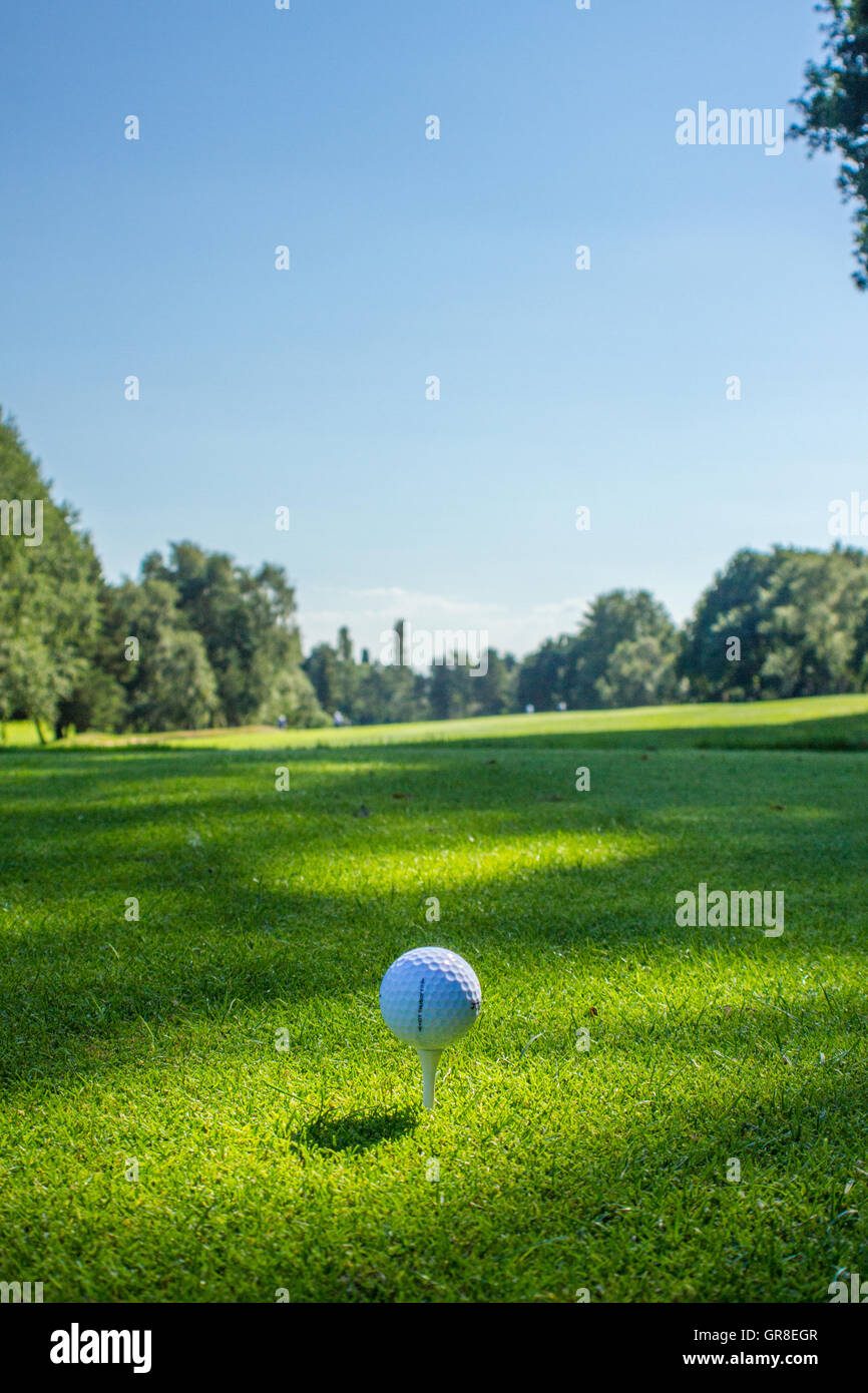 Colour image of a golf ball highlighted by sun-light on 1st Tee Stock ...
