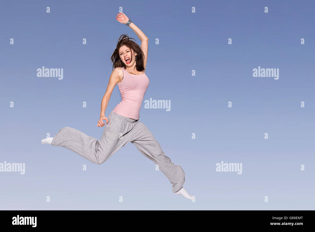 Young Woman Jumping High In The Air Stock Photo - Alamy