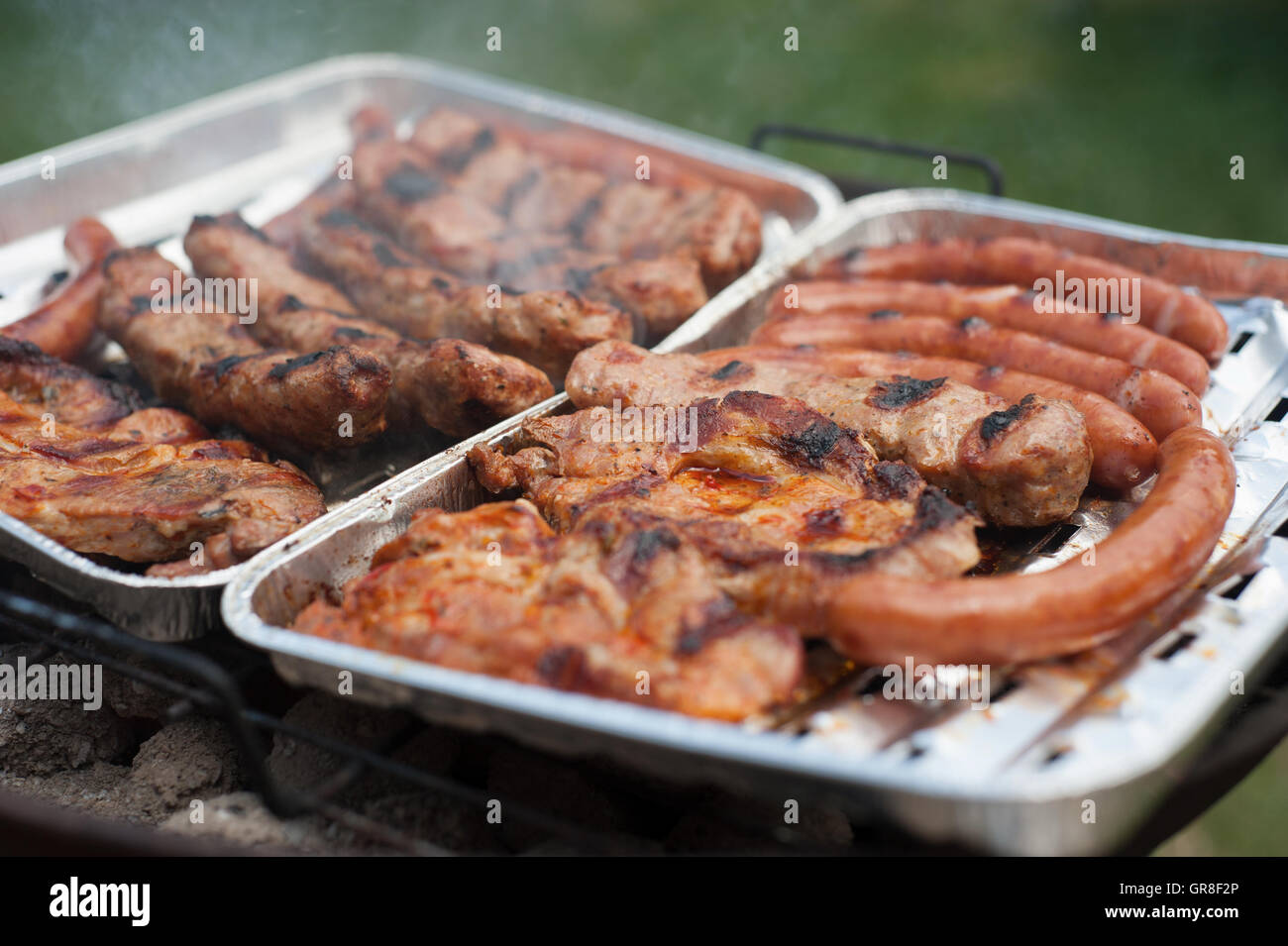 BBQ season grilling meat Stock Photo - Alamy