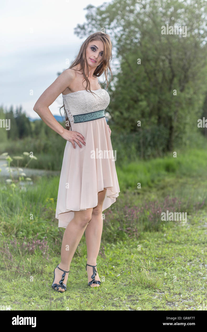 Woman In Elegant Pearly Sundress Undertakes Walk Stock Photo - Alamy