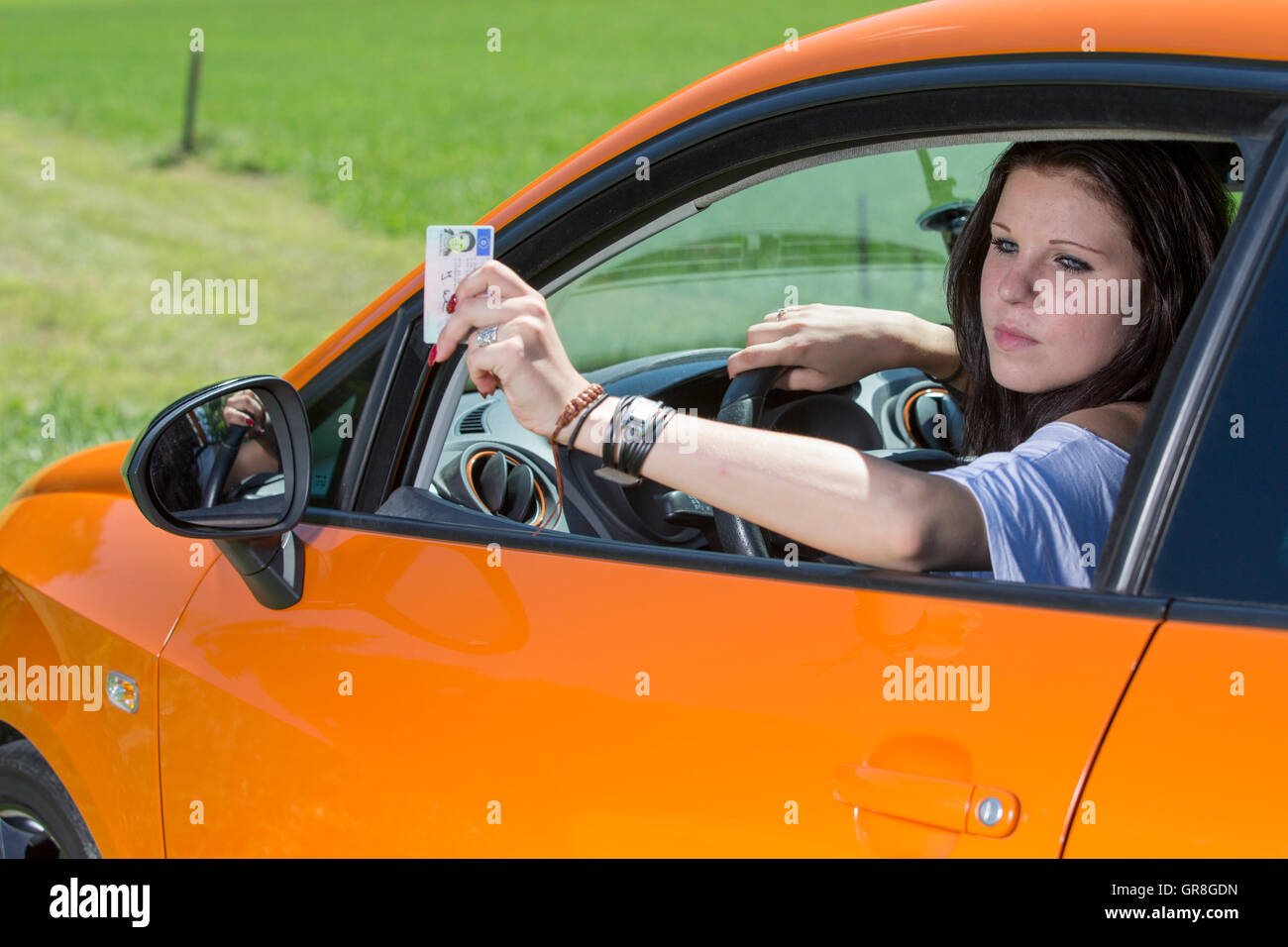 Young Woman Pointing At A Road Check A Driving License Stock Photo - Alamy