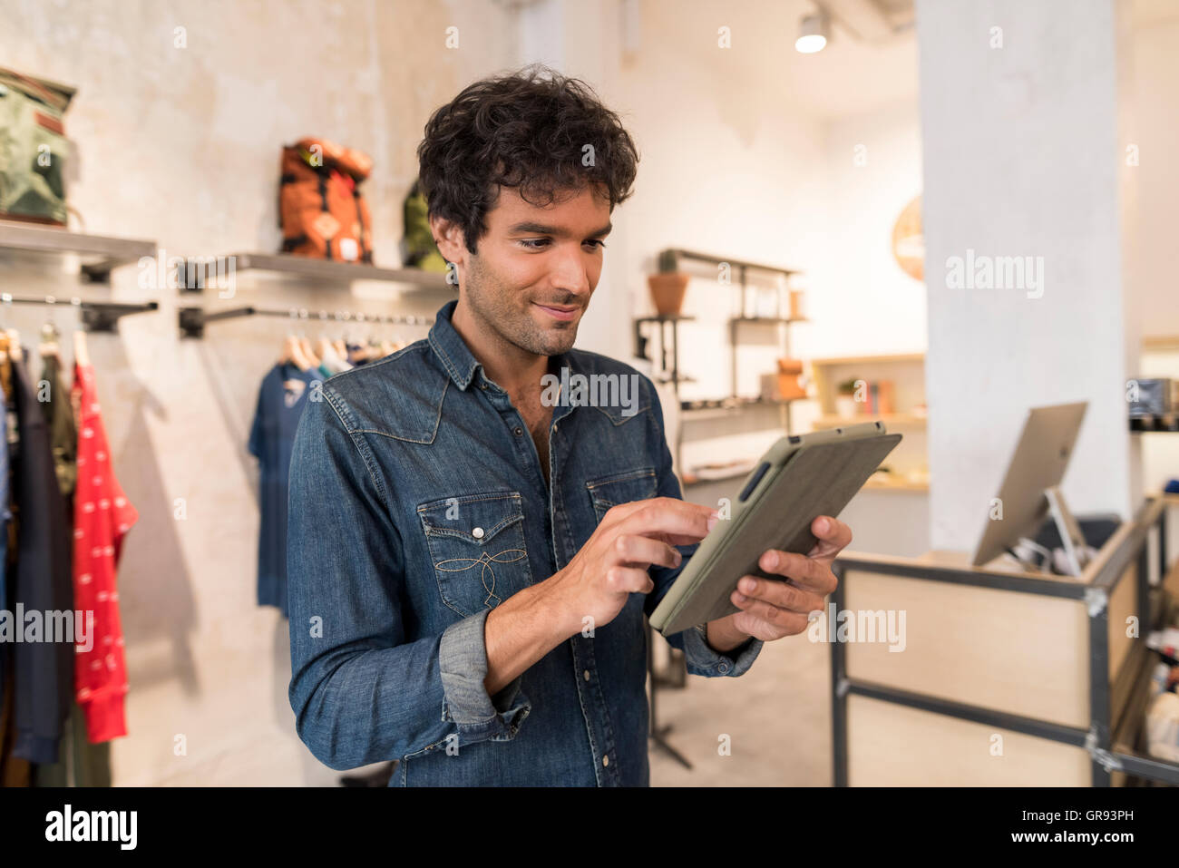 Male owner of Fashion Store with digital tablet computer Stock Photo ...