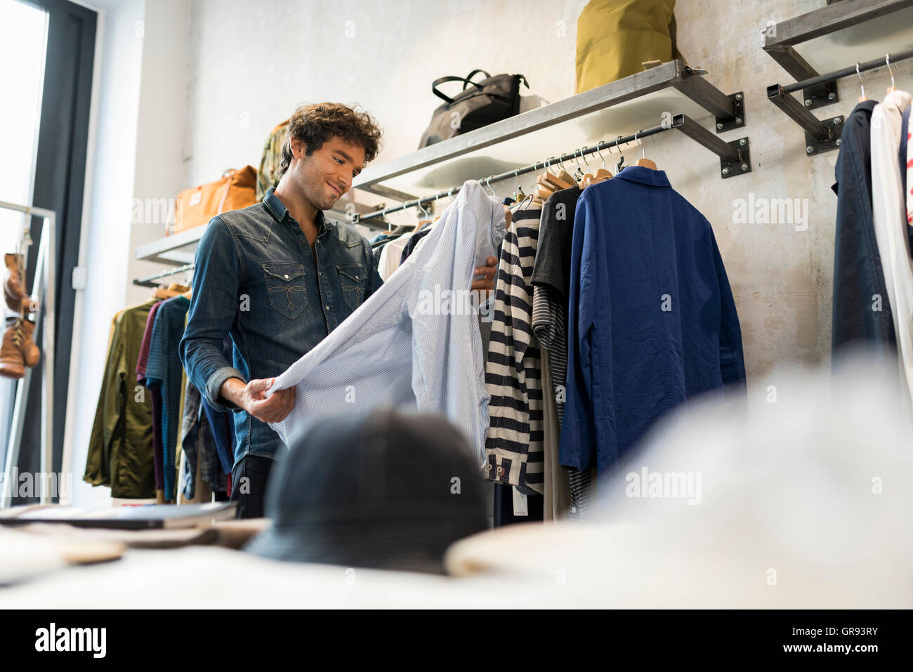 Man makes shopping in clothing store Stock Photo - Alamy