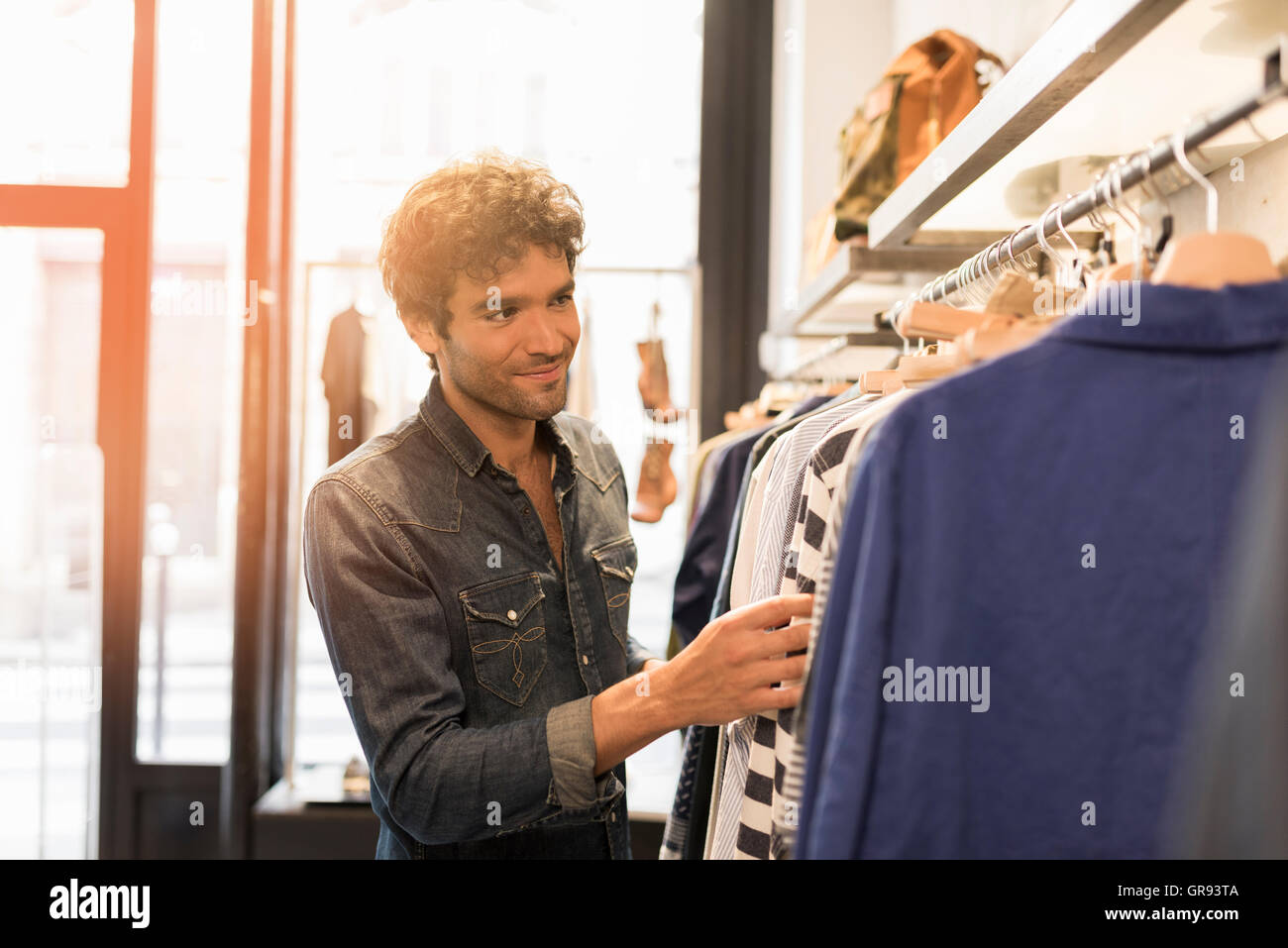 Man makes shopping in clothing store Stock Photo - Alamy