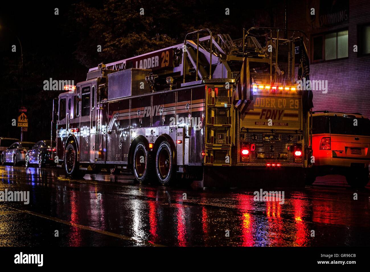 Illuminated Fire Engine On Street At Night Stock Photo - Alamy