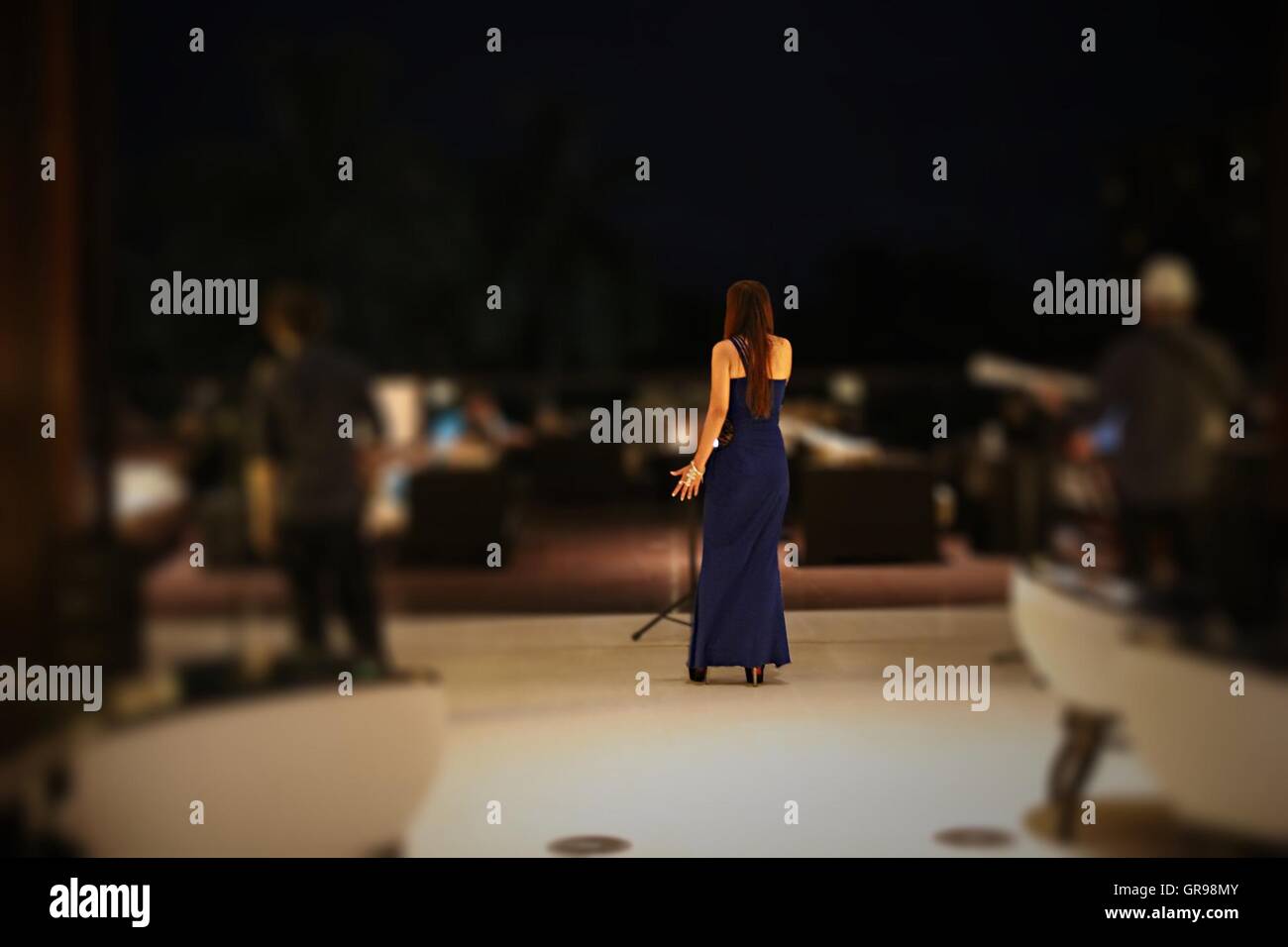 Tilt-Shift Image Of Woman Signing On Stage At Music Concert Stock Photo ...