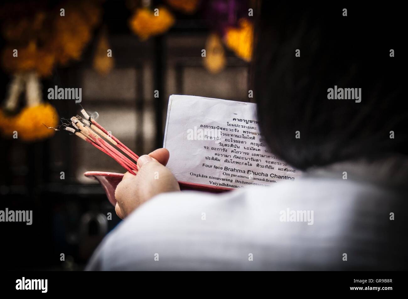 Rear View Of Person Holding Prayer Book And Insane Stick Stock Photo ...