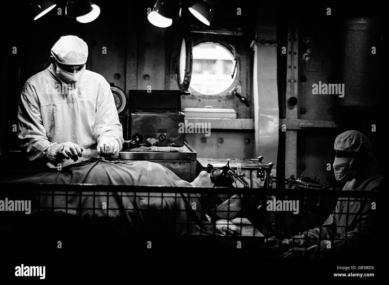 Doctor standing in operating room Black and White Stock Photos & Images ...