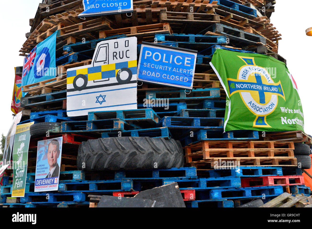 RAF, Unionist, Sinn Fein and PSNI flags and signs on bonfire in Derry’s ...