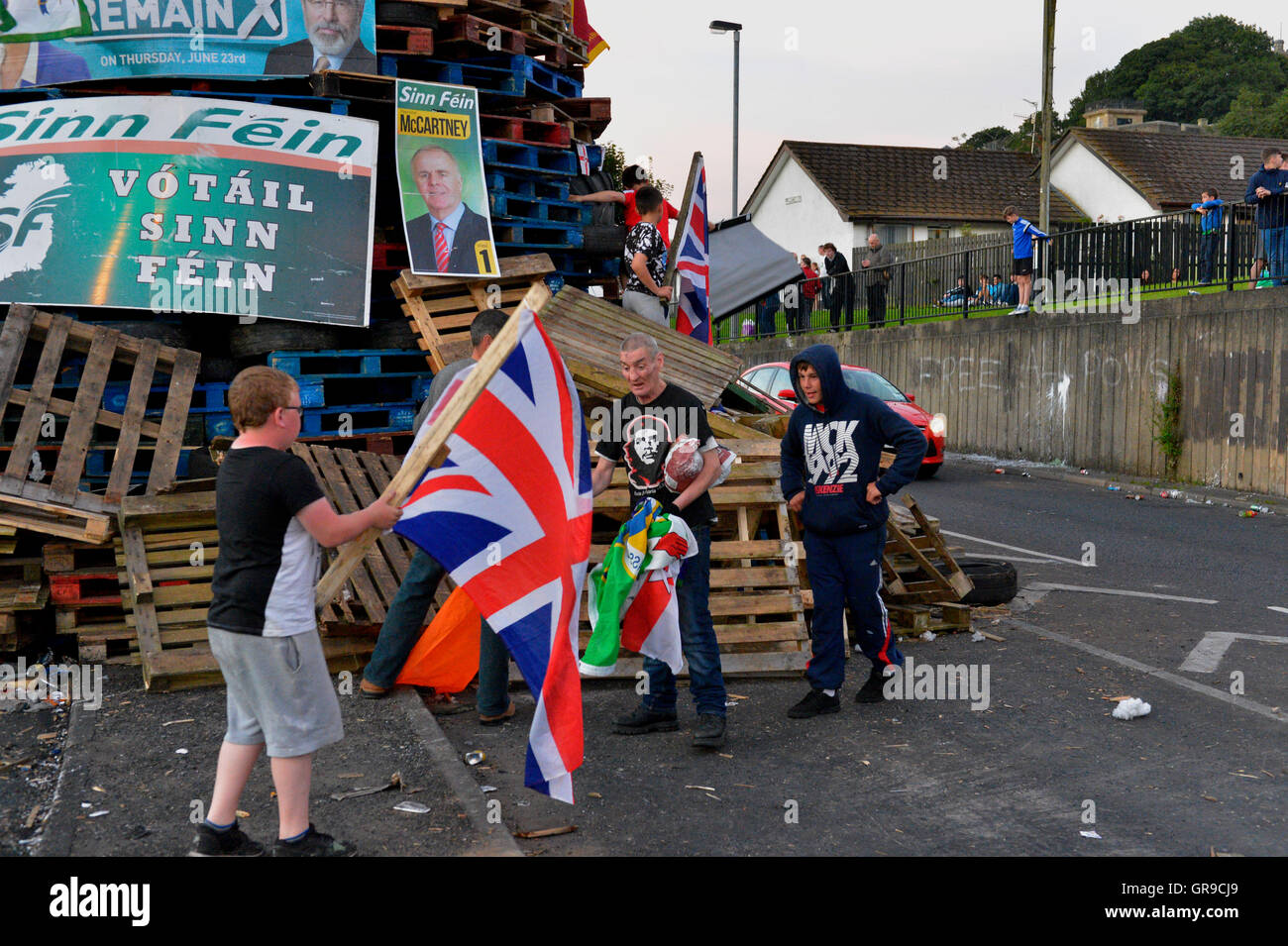 Children put a Union Jack flags on bonfire in Derry’s Bogside. ©George ...