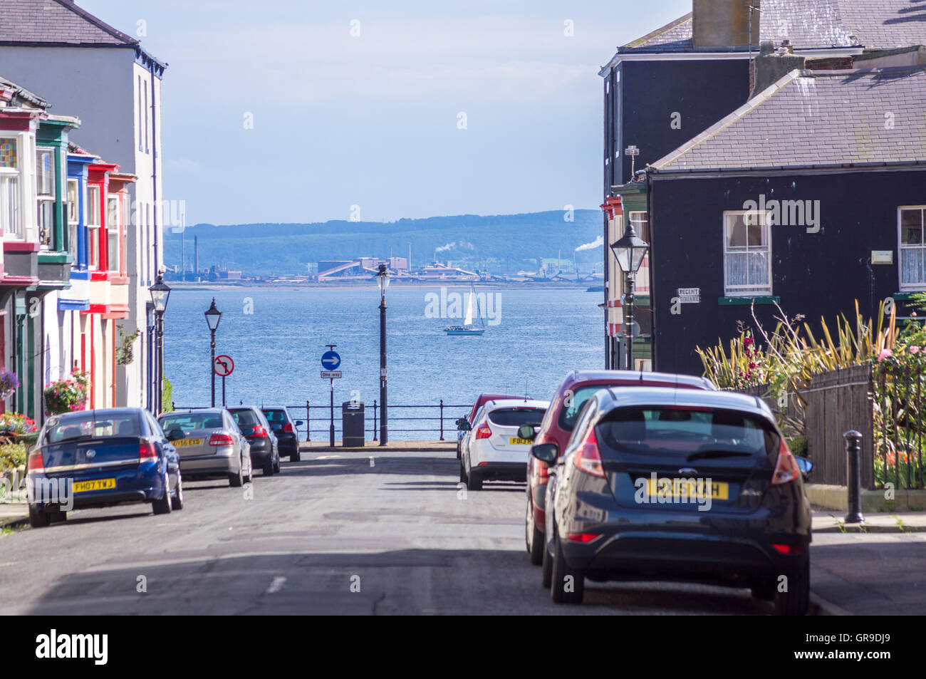 A yacht in Hartlepool Bay seen from a street of Victorian terraced ...