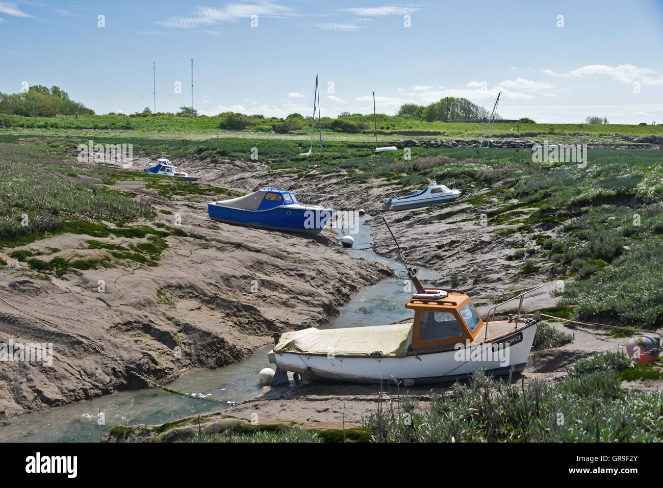 Boats moored in the creeks leading through the estuary of Blind Yeo and ...