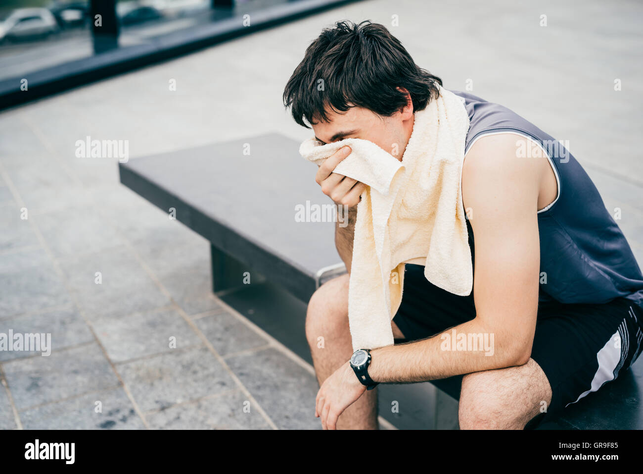 Young handsome caucasian brown hair sportive man drying himself with a ...