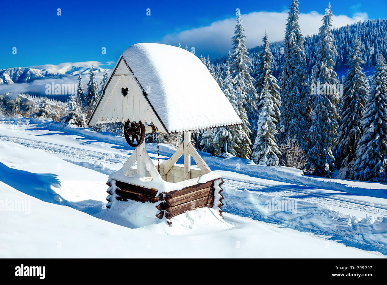 beautiful romantic old style well with wooden roof and heart shape ...
