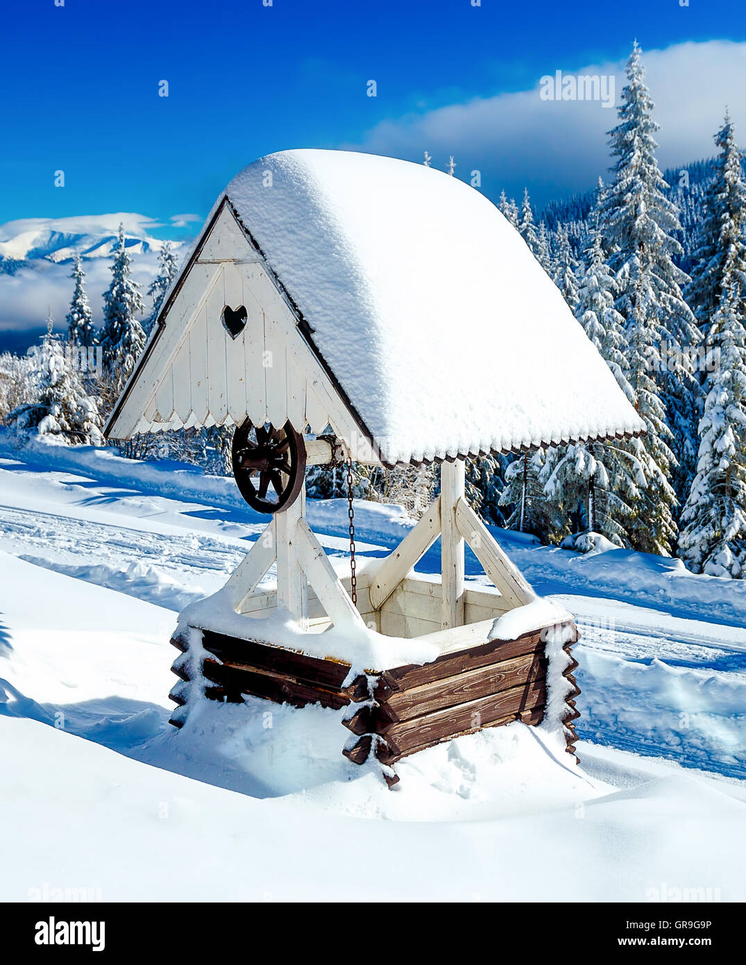 beautiful romantic old style well with wooden roof and heart shape ...