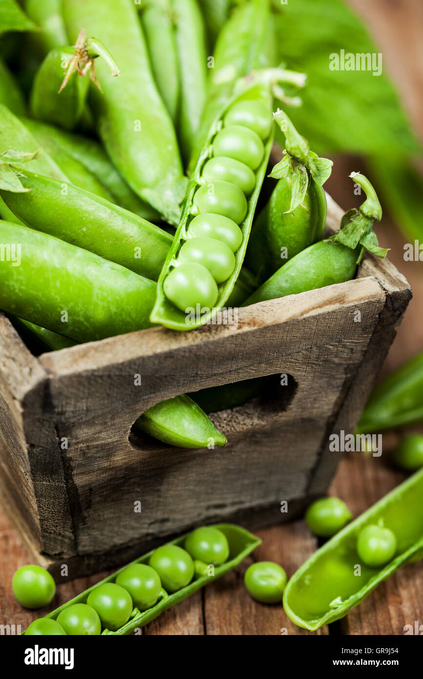 Fresh ripe green peas in wooden box Stock Photo - Alamy