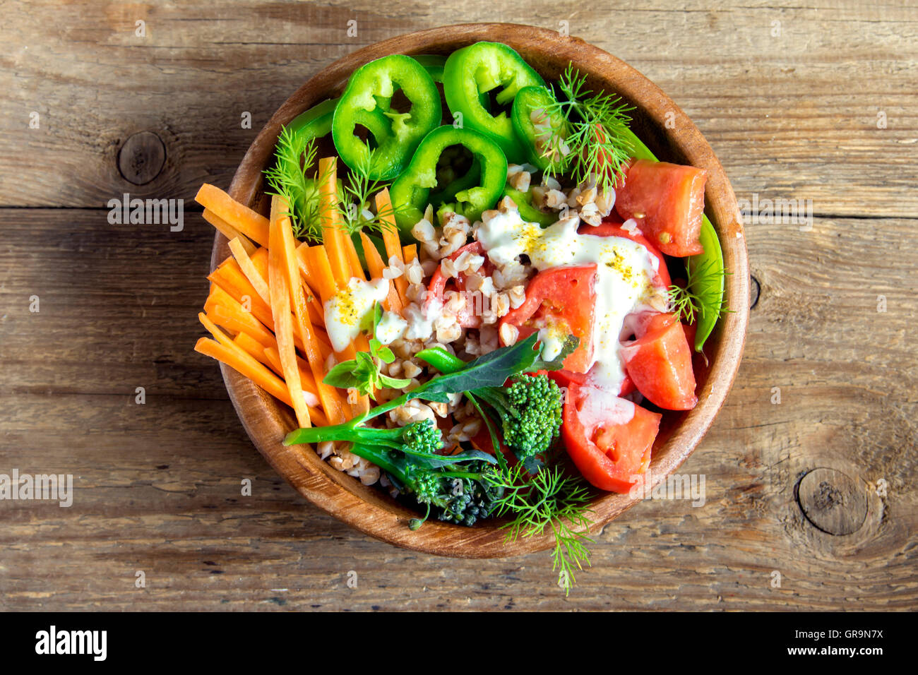 Fresh organic vegetable salad with buckwheat over rustic wooden ...