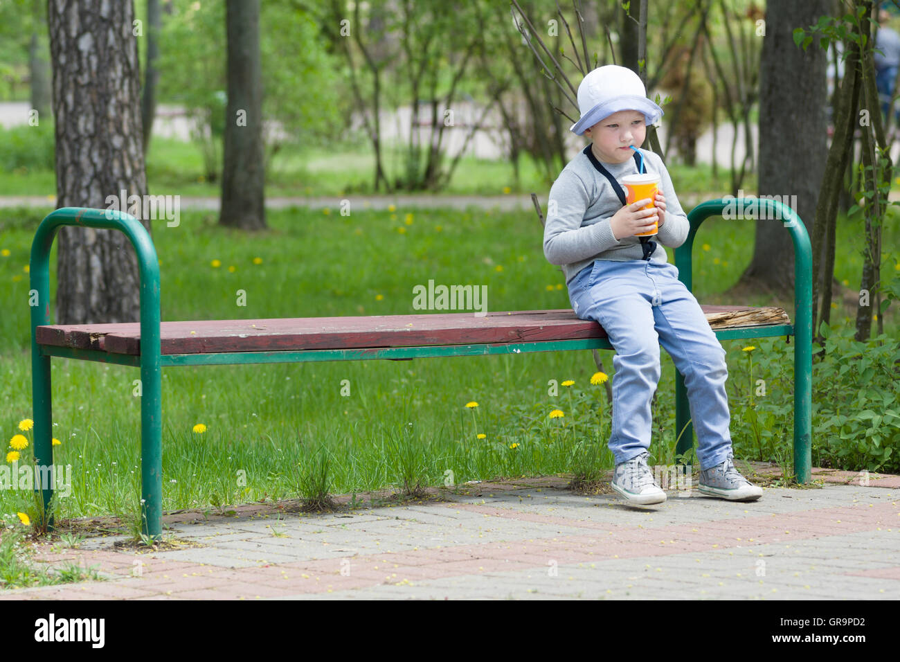 Boys sitting on bench hi-res stock photography and images - Alamy