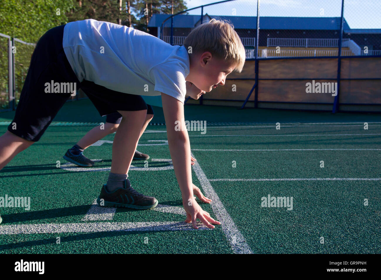 Sports boys (children) on starting position ready to run. Children's ...
