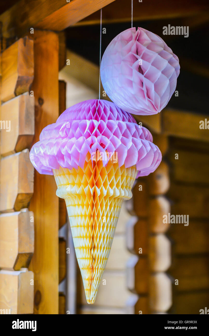 pink paper ice cream hanging on a wooden girder Stock Photo - Alamy