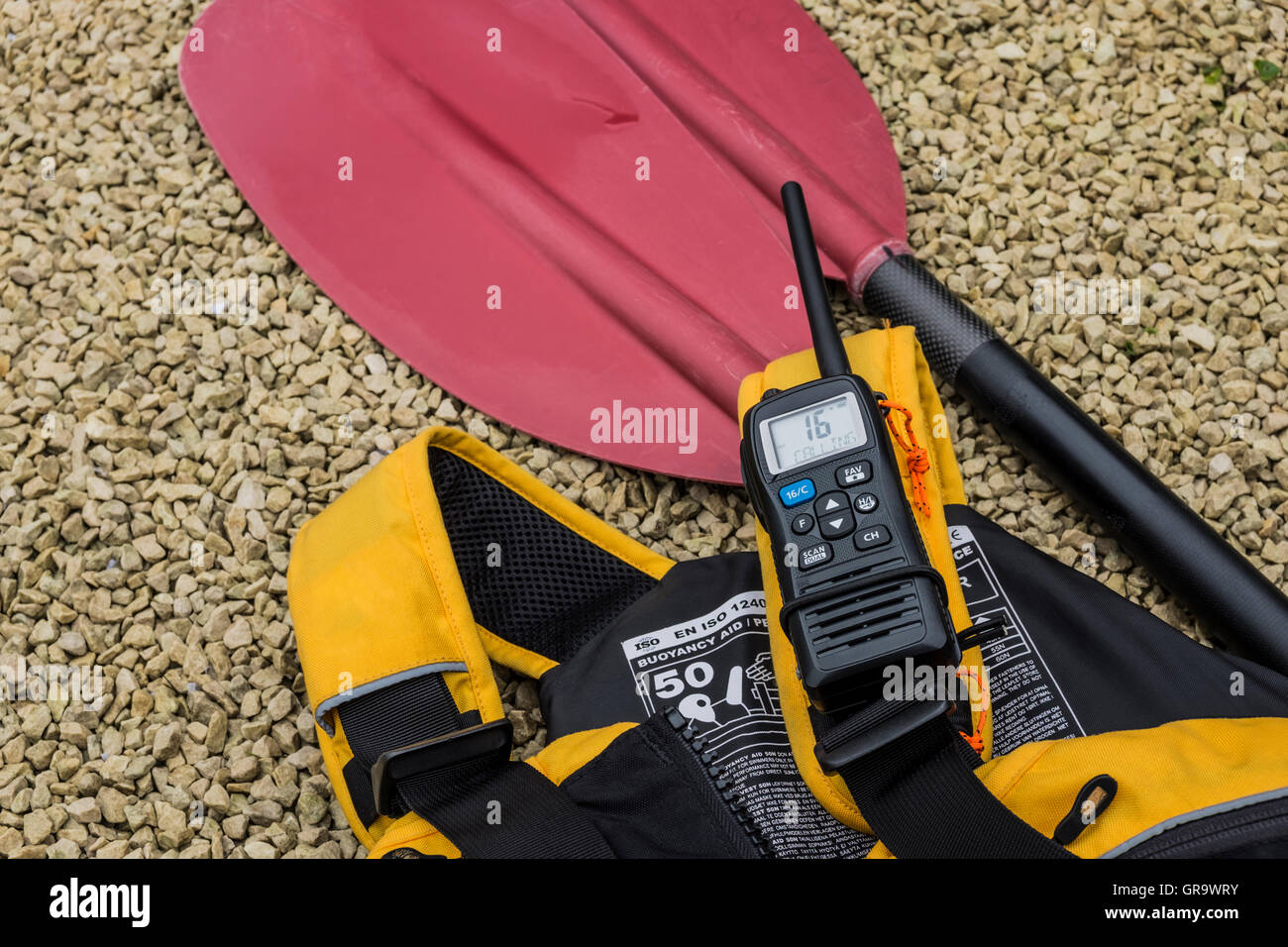 Kayak paddle, buoyancy aid and VHF radio Stock Photo - Alamy