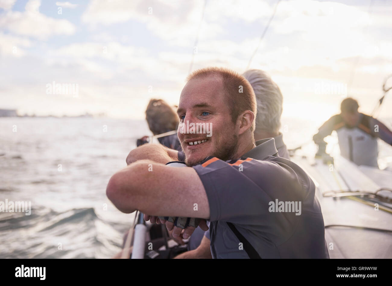 Smiling man sailing on sailboat Stock Photo - Alamy
