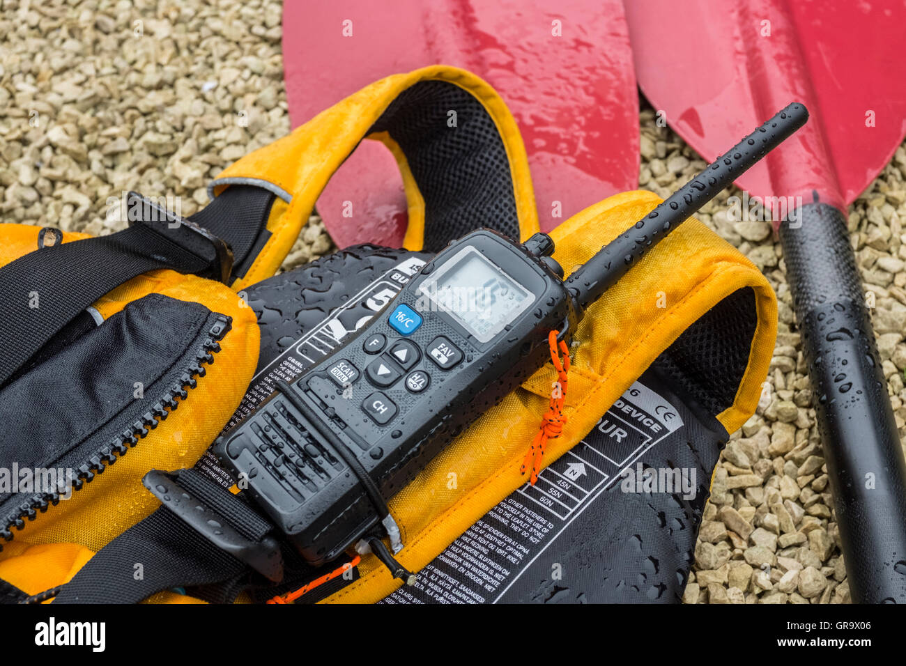 Kayak paddle, buoyancy aid and VHF radio Stock Photo - Alamy