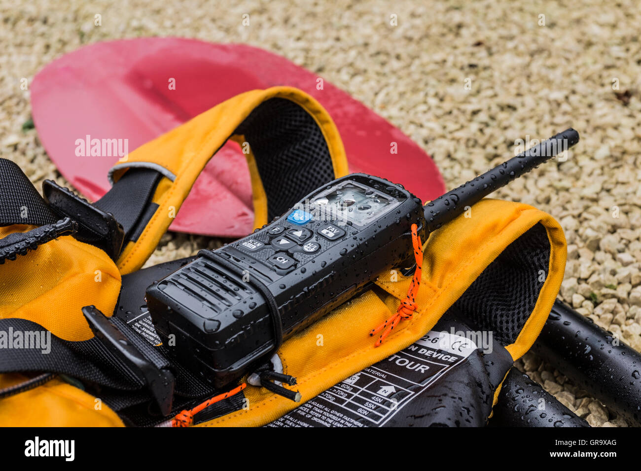 Kayak paddle, buoyancy aid and VHF radio Stock Photo - Alamy