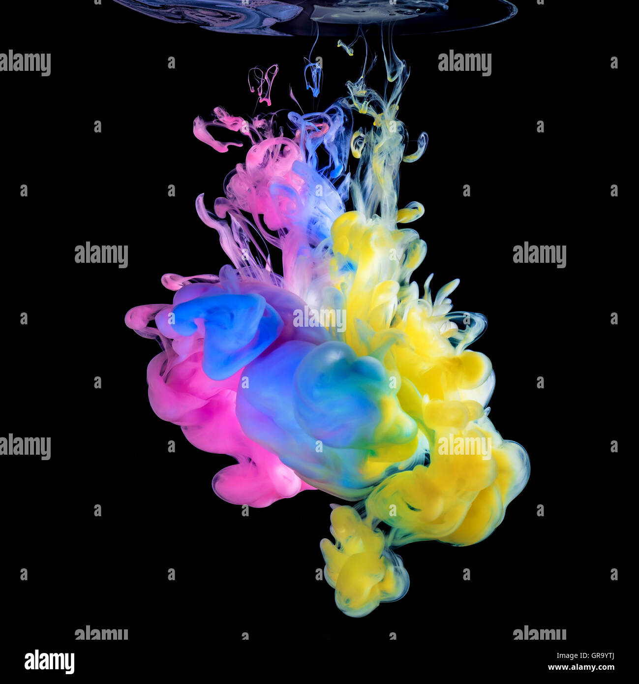 Colored inks in water on black background Stock Photo - Alamy