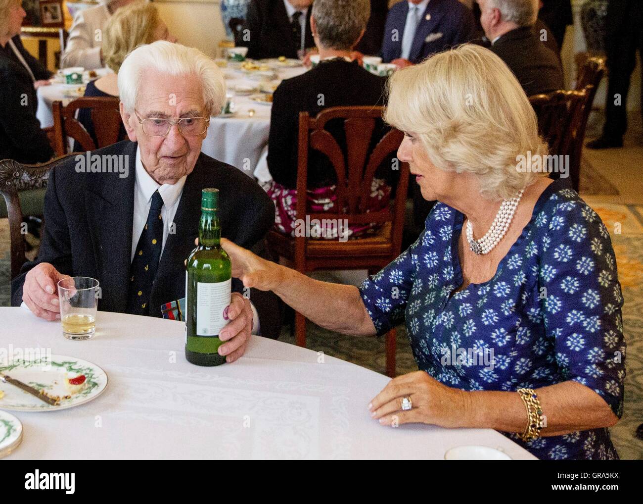 The Duchess of Cornwall (right) presents Flight Officer Ken Wilkinson ...