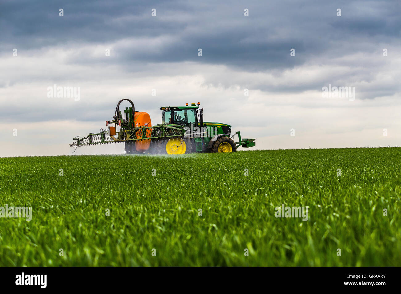 Spraying crops in the field Stock Photo - Alamy
