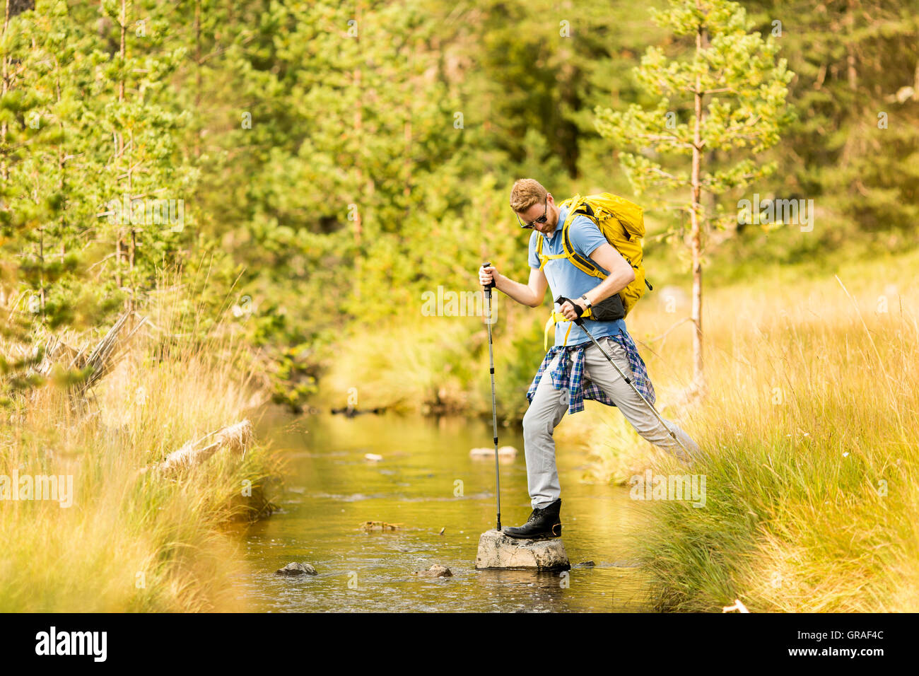 Young man crosses mountain hi-res stock photography and images - Alamy