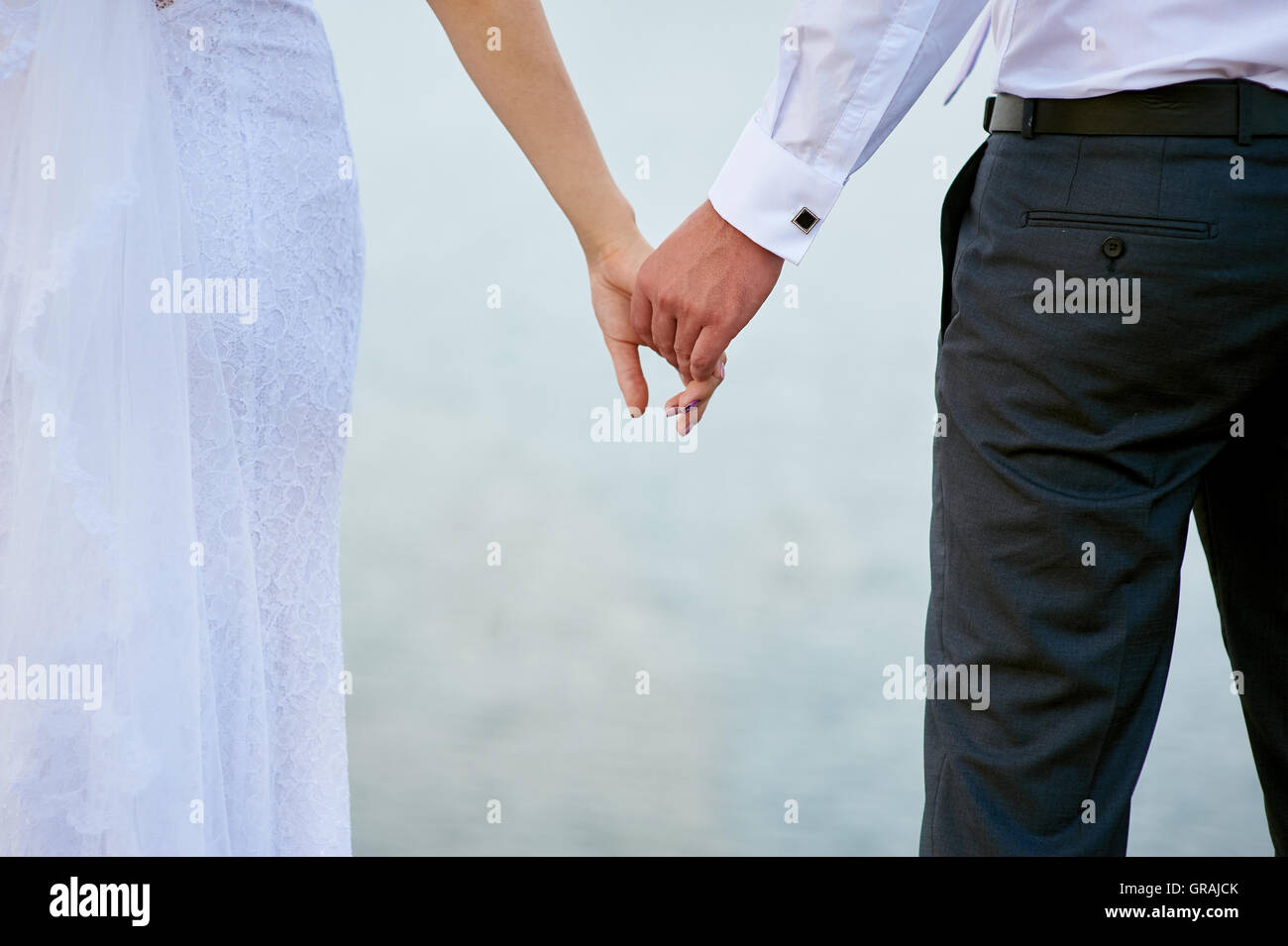 Wedding photo of bride and groom holding hands Stock Photo - Alamy