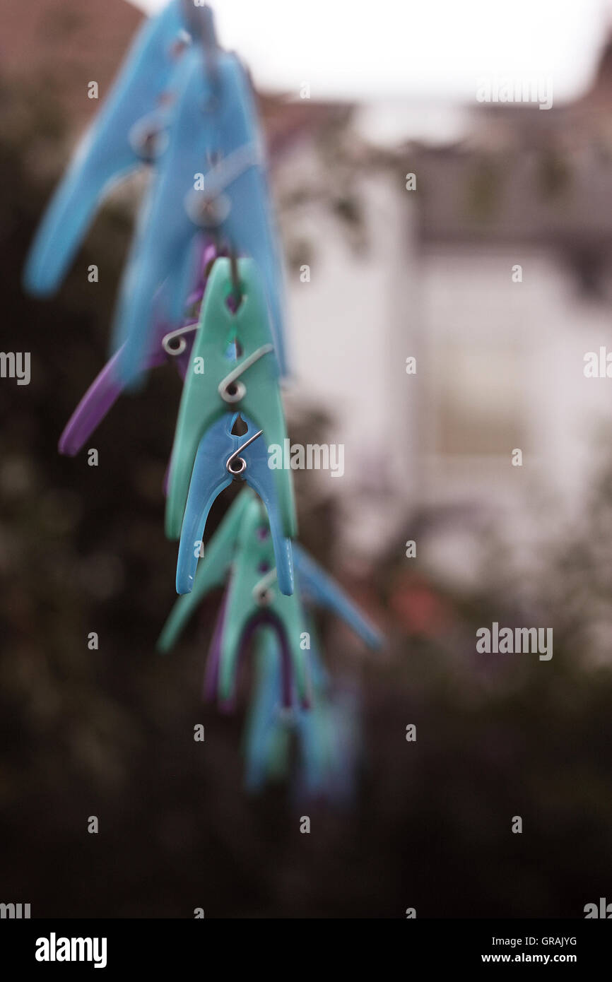 A colourful bunch of clothes pegs hanging on a washing line Stock Photo ...