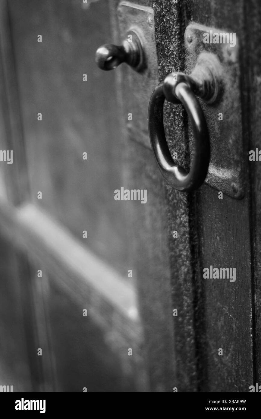 An old door with a cast iron ring handle Stock Photo - Alamy