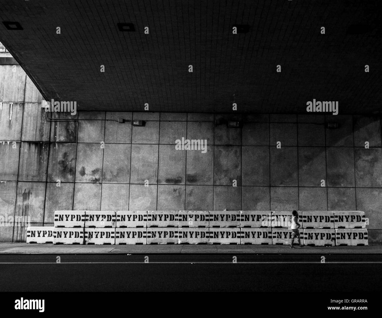 Side View Of A Man Walking Against Wall Stock Photo - Alamy