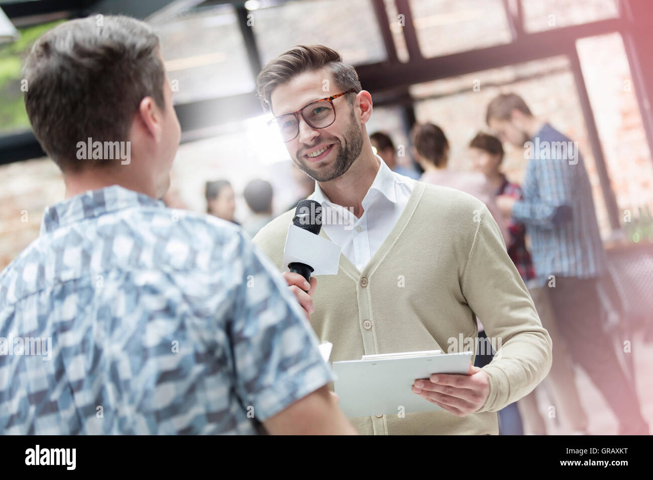 Speaker with microphone at technology conference Stock Photo - Alamy