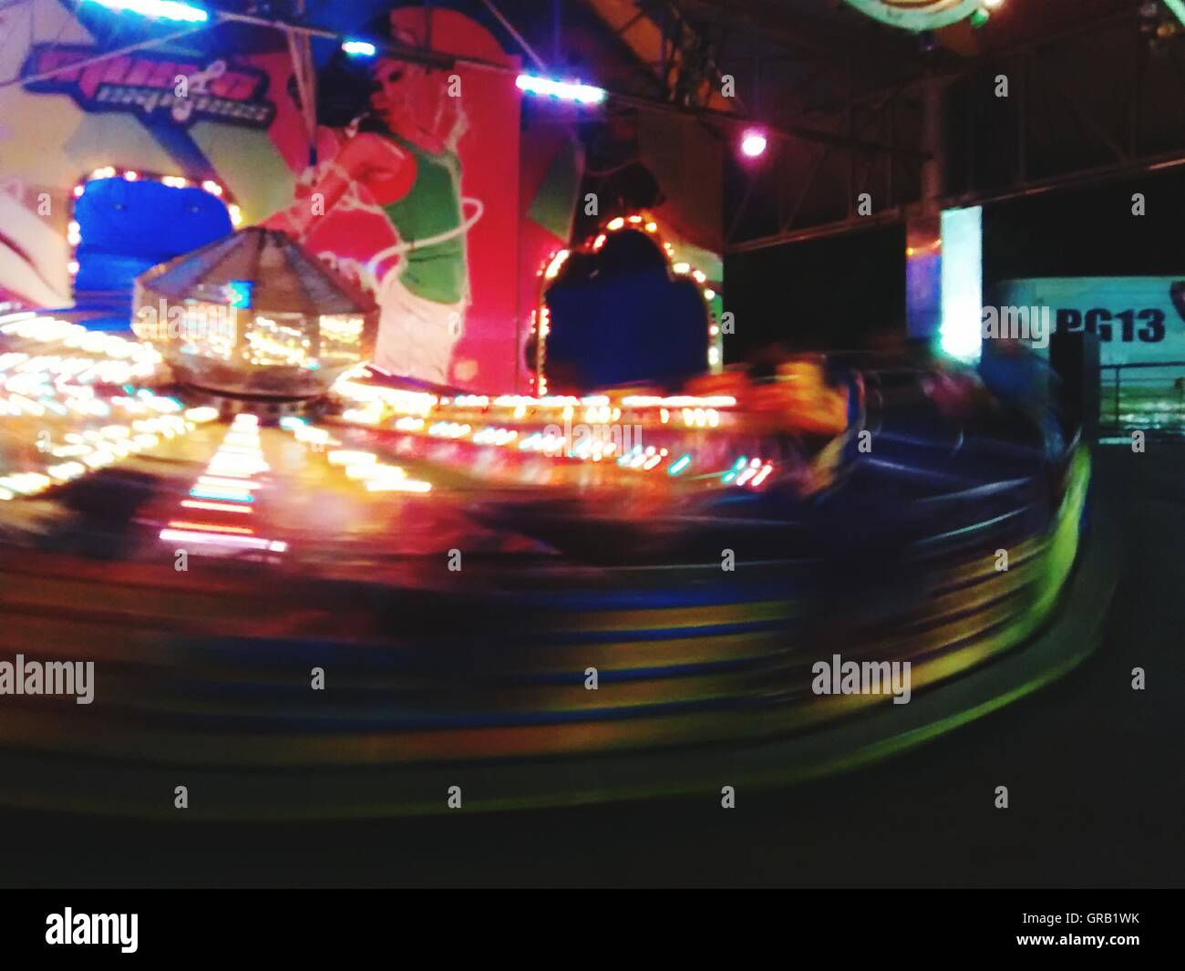 Spinning Illuminated Amusement Park Ride At Night Stock Photo - Alamy