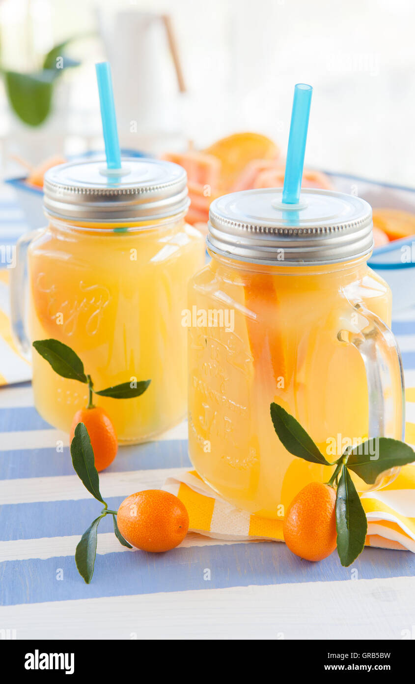 Orange Juice In Rustic Jars Stock Photo - Alamy