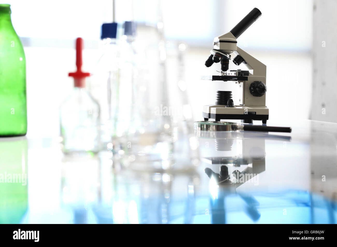 Workshop laboratory microscope stands on a glass countertop Stock Photo ...