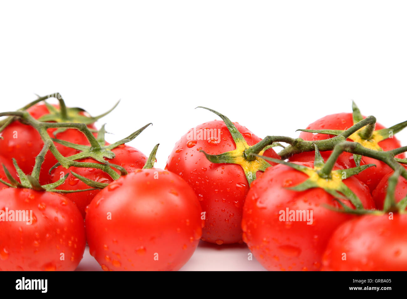 Two clusters of small red tomatoes on a branch Stock Photo - Alamy
