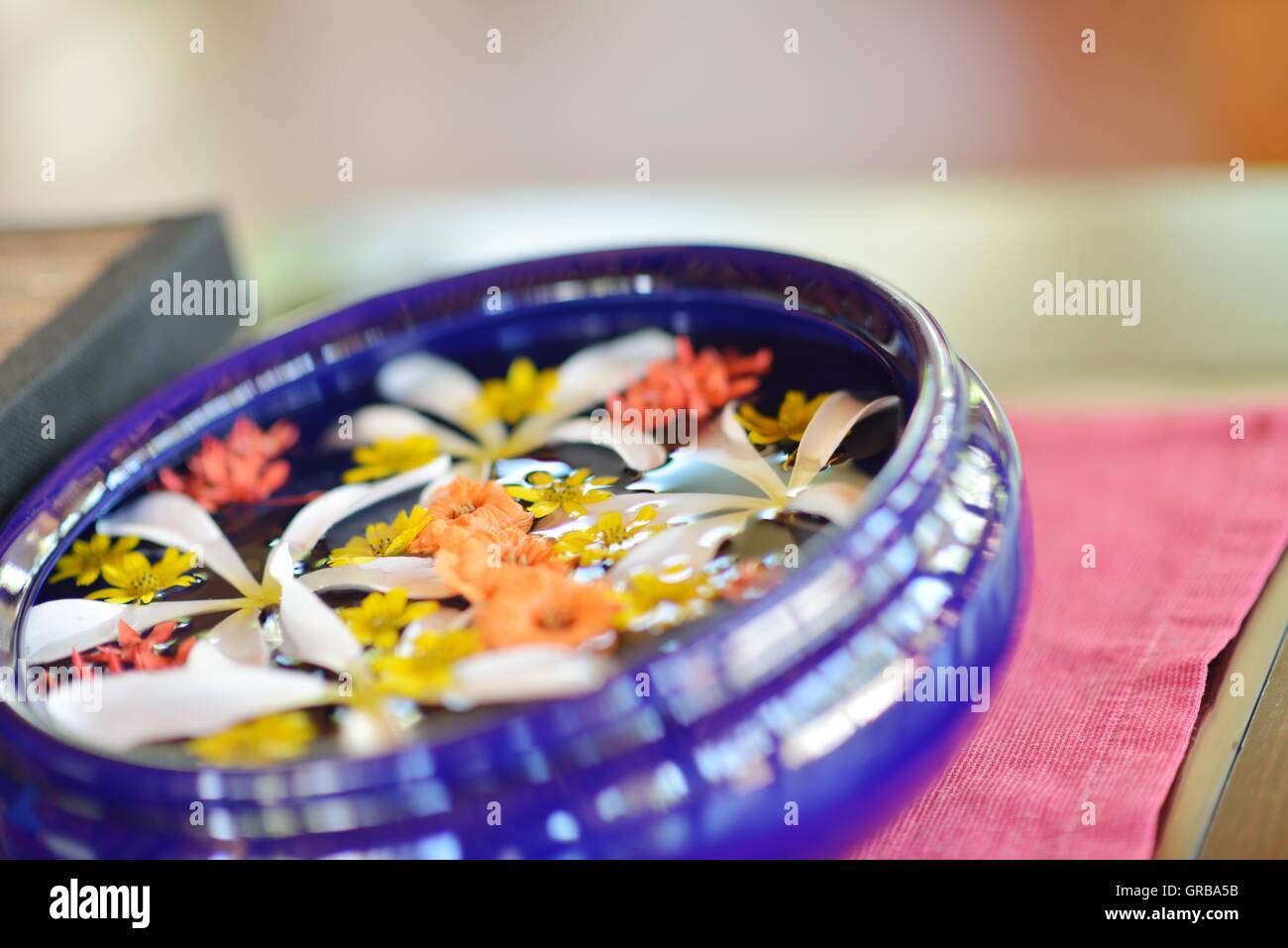 water cup with beautiful flowers background Stock Photo - Alamy