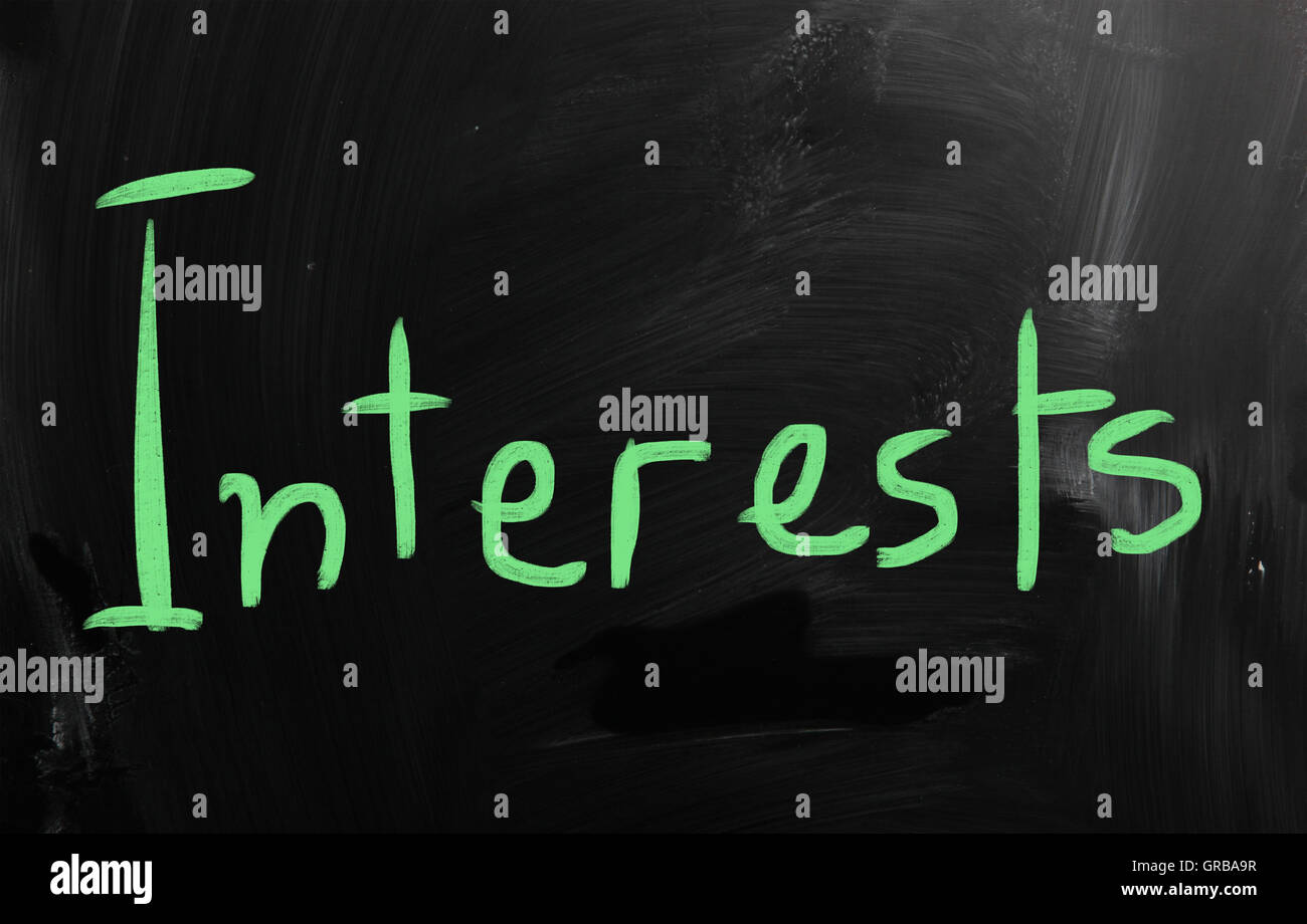 Interests handwritten with white chalk on a blackboard Stock Photo - Alamy