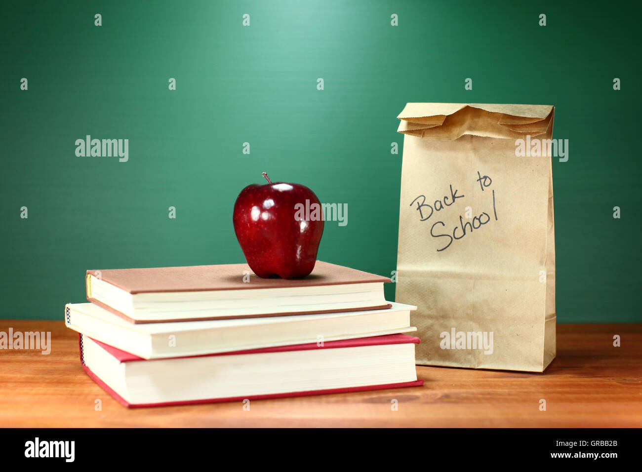 Books, Apple and Lunch on Teacher Desk Stock Photo - Alamy