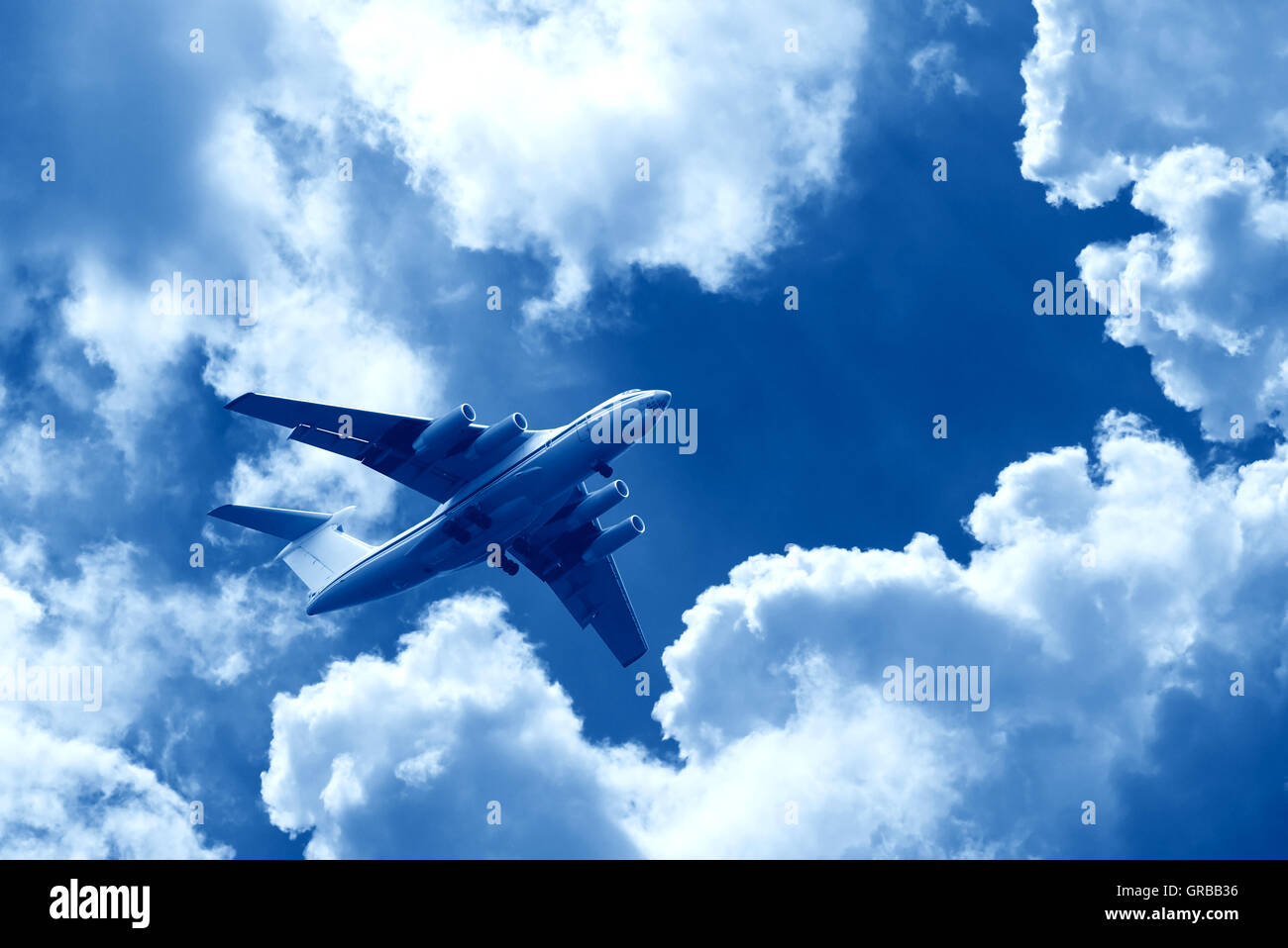 Airplane In Clouds Stock Photo - Alamy